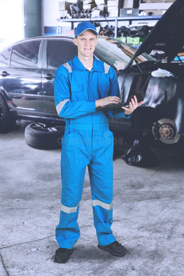 American Mechanic with Laptop in the Workshop Stock Photo - Image of ...
