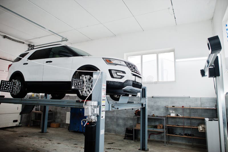 American SUV Car on Stand for Wheels Alignment Camber Check in Workshop ...