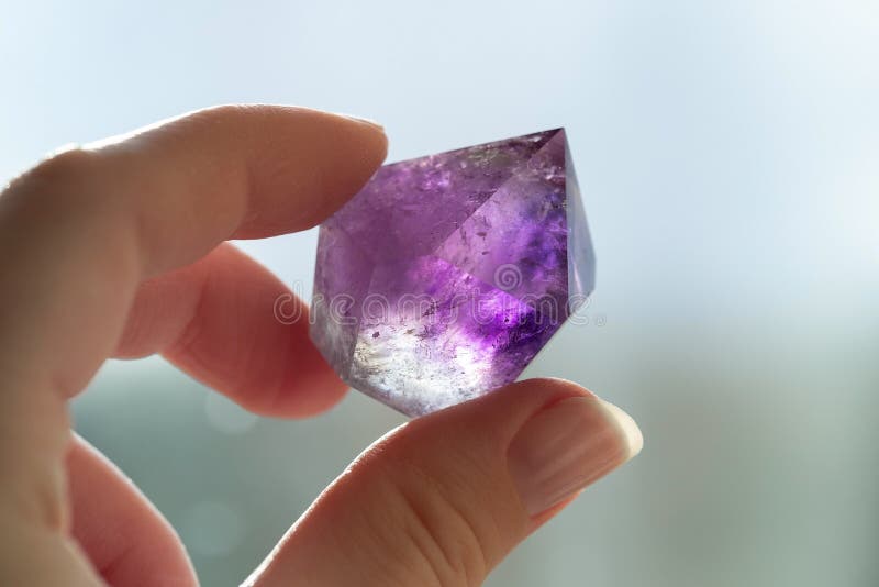 Amethyst Crystal in Hand. Purple Translucent Crystal Close-up Stock ...