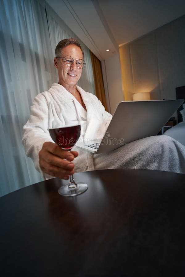 Amicable Man Relaxing with Wine and Getting Some Work Done Stock Image ...