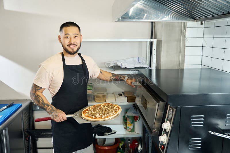 Friendly Guy Posing with a Handmade Pizza in Kitchen Stock Image ...
