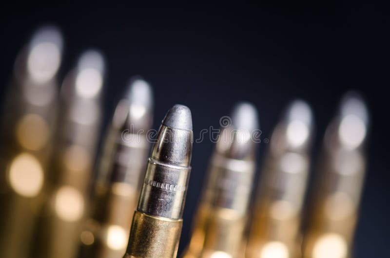 Ammunition on a Dark Blue Background with Reflection in a Glass. Close ...