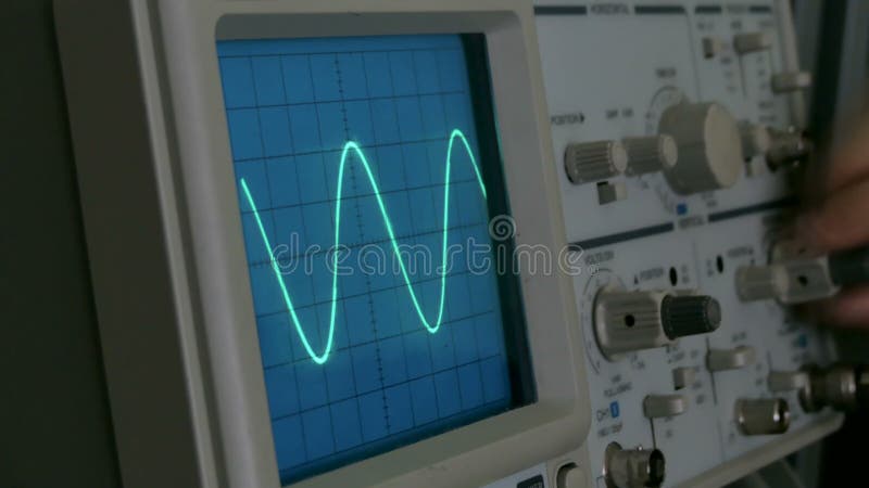 Amplitude Diagram on the Oscilloscope. a Man Presses the Buttons on the ...