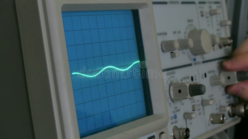 Amplitude Diagram on the Oscilloscope. a Man Presses the Buttons on the ...