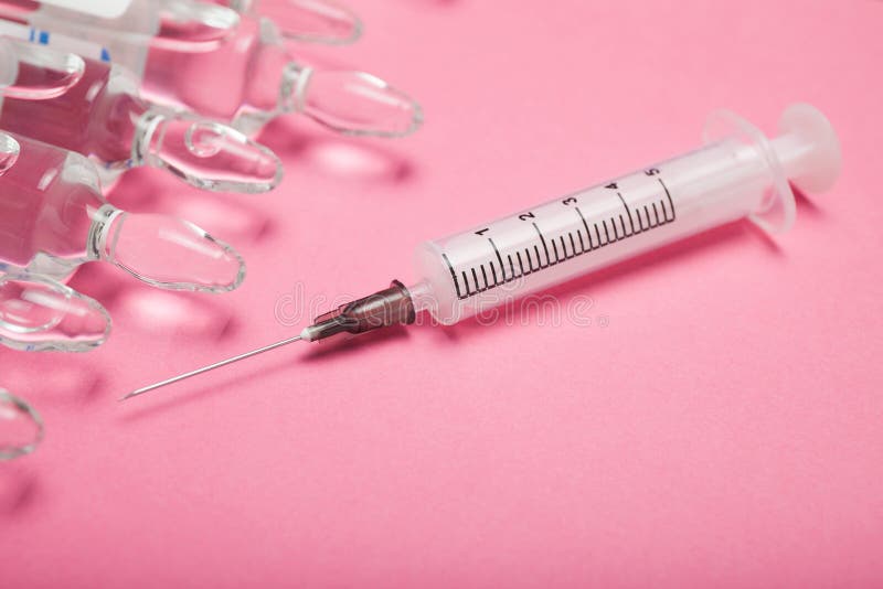 Ampoules on a Pink Background, Syringe. Face Aging, Rejuvenation and ...