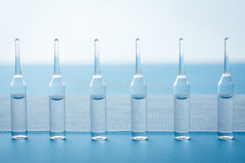 Ampules and a Syringe on Blue Background Stock Photo - Image of ...