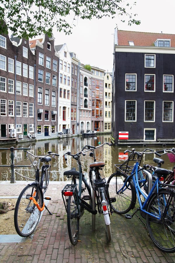 Riding a bike in Amsterdam stock image. Image of rusty - 33153395