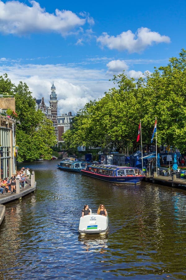 Amsterdam Canal Scene with a Paddle Boat Editorial Photography - Image ...