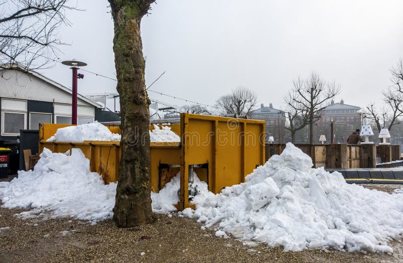 Large Orange Bin Below a Tree Filled with Residual Artificial Snow ...