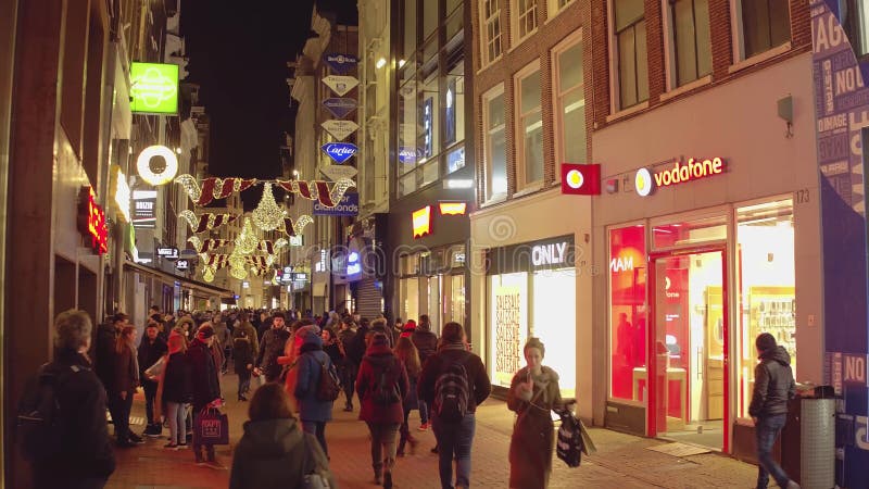 AMSTERDAM, NETHERLANDS - DECEMBER 28, 2017. Crowded Street and Lit ...