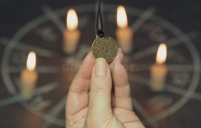 Amulet of Predictions in Hand on the Background of the Magic Circle ...