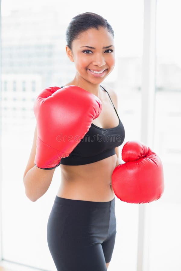 Amused Dark Haired Model In Sportswear Wearing Red Boxing Gloves Stock