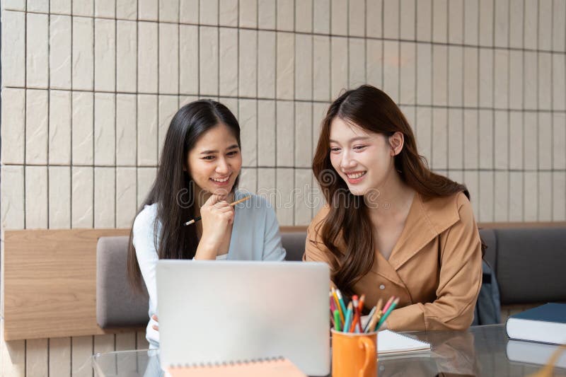Study Break and Laughter. Two Students Share a Light Moment while Collaborating on Their ...