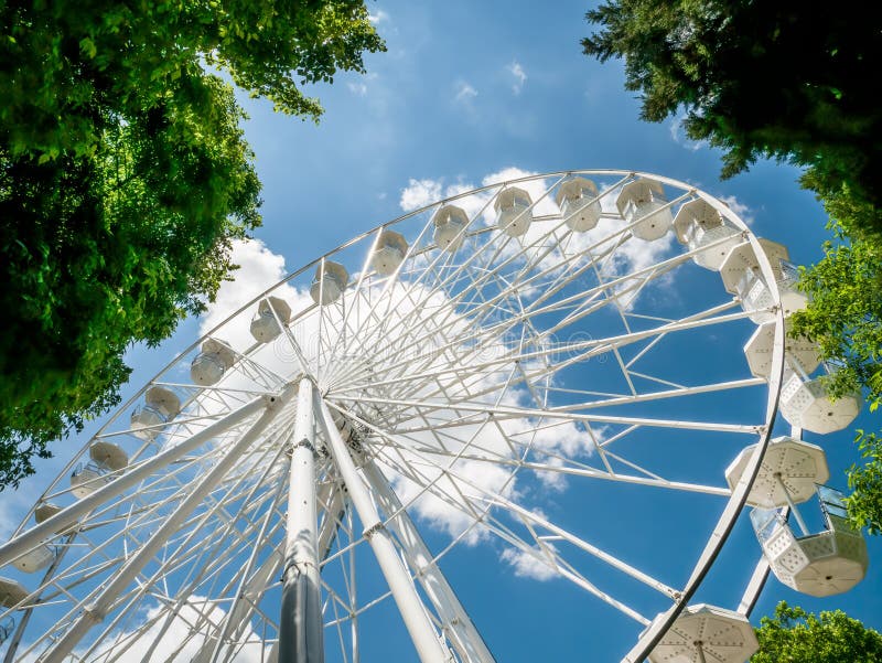 Amusement Ride Against Blue Sky. Close Up with a White Ferrys Wheel ...