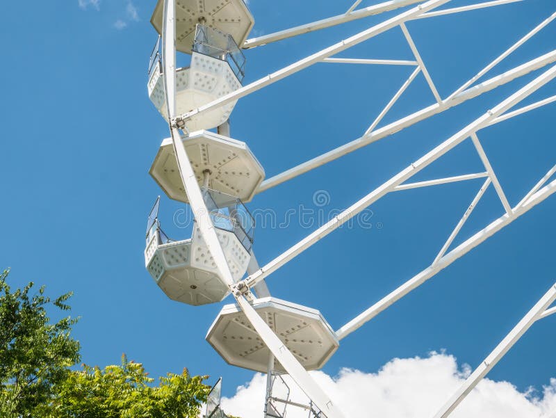 Amusement Ride Against Blue Sky. Close Up with a White Ferris Wheel ...
