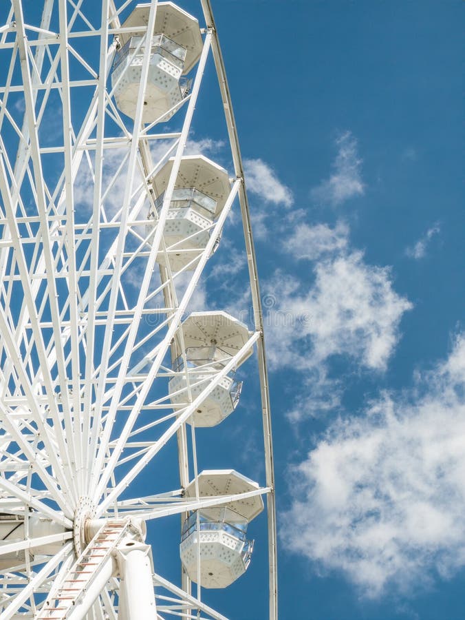 Amusement Ride Against Blue Sky. Close Up with a White Ferris Wheel ...