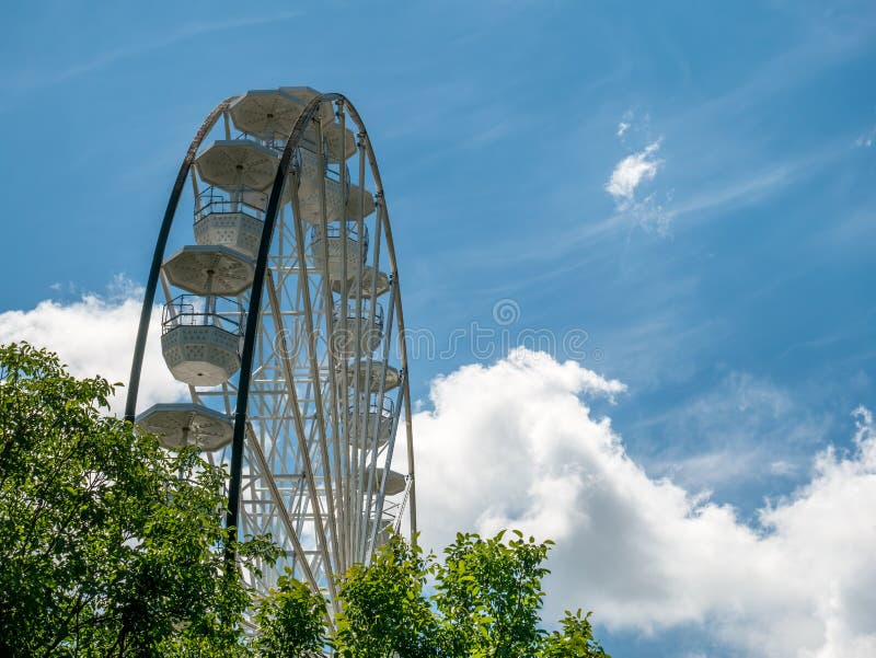 Amusement Ride Against Blue Sky. Close Up with a White Ferris Wheel ...