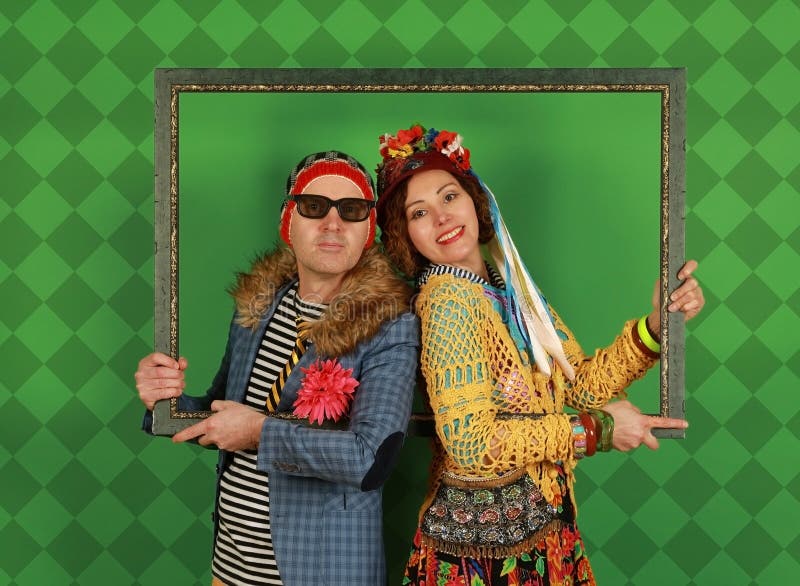 Funny Freaky Couple Posing in the Studio Holding a Picture Frame in ...