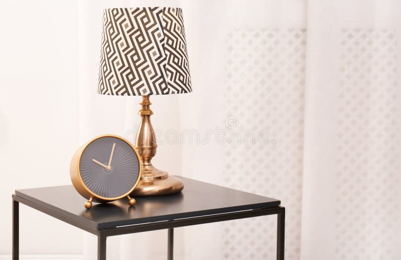 Analog Clock and Lamp on Table Indoors, Space for Text. Stock Photo ...