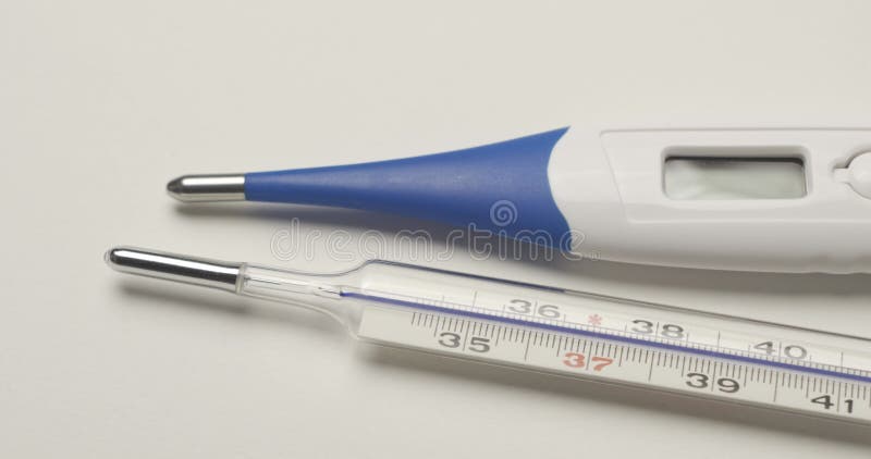 Analog and Digital Clinical Thermometer on White Surface. Panning ...