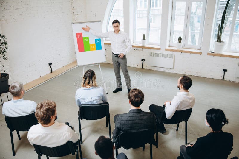 Male Speaker Giving Presentation in Hall at Workshop. Audience or ...