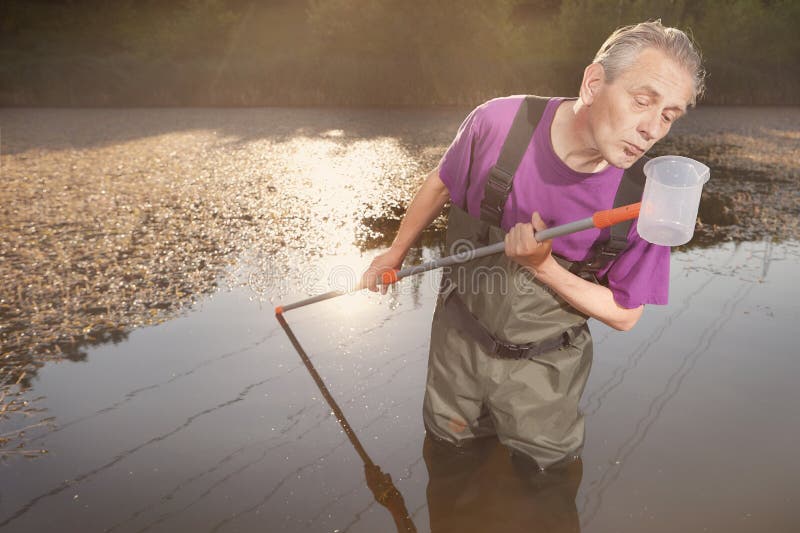 Analyst in Chest Waders Bootfoot Collecting Samples of Water Stock ...