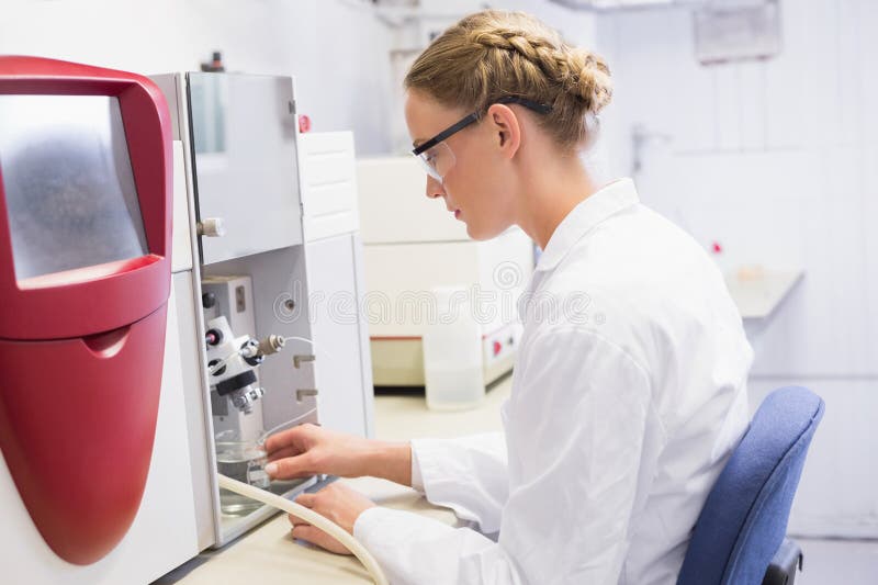 Analytical Instrument Processing Samples at Bright Lab Bench, with Red ...