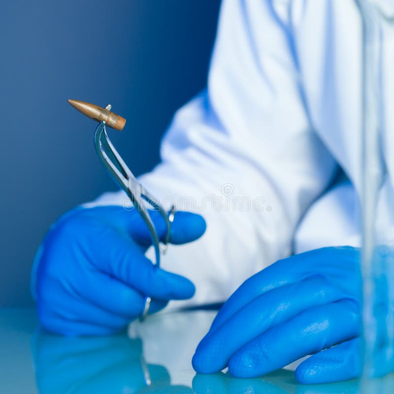 Analyzing a Bullet in the Lab Stock Photo - Image of examination, clue ...