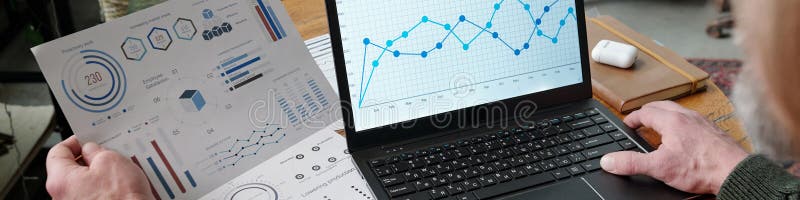 Analyzing Data Charts on Laptop and Paper Document Stock Photo - Image ...