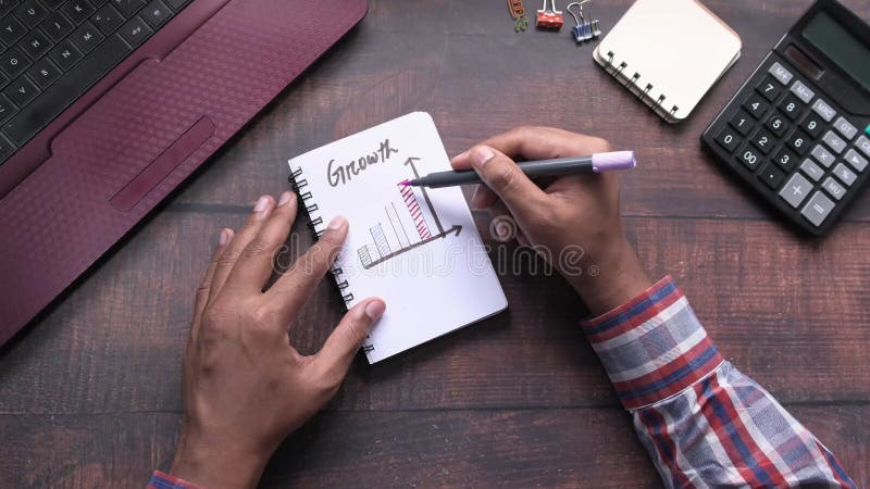 Analyzing Hand Drawn Growth Chart on Notepad at Office Desk Stock Video ...