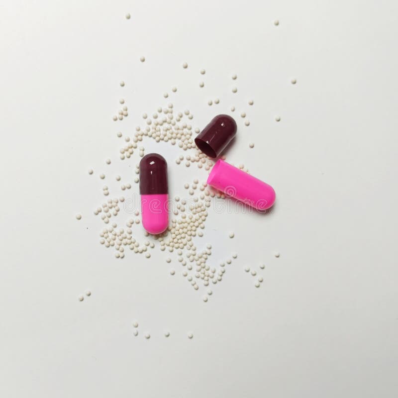 Analyzing Medication Capsules with Small White Beads Stock Photo ...