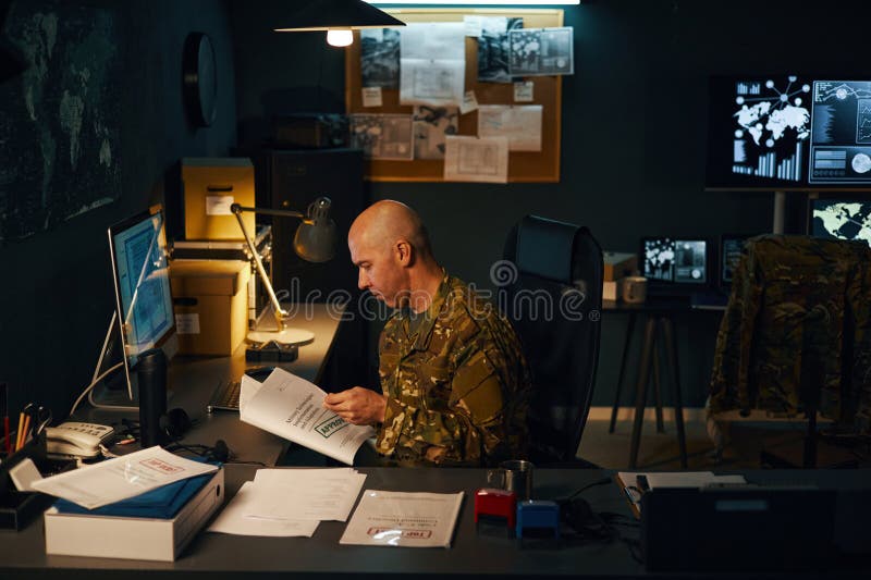 Analyzing Military Documents in Office Environment Stock Photo - Image ...