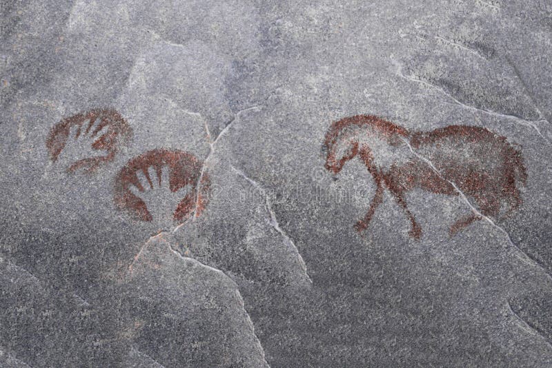 Ancient Animal, Human Hands on the Wall of the Cave. Stock Image ...