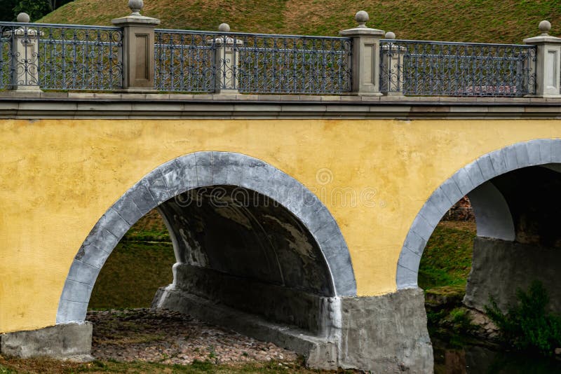 An Ancient Arched Bridge Over the Moat To the Castle. Architectural ...