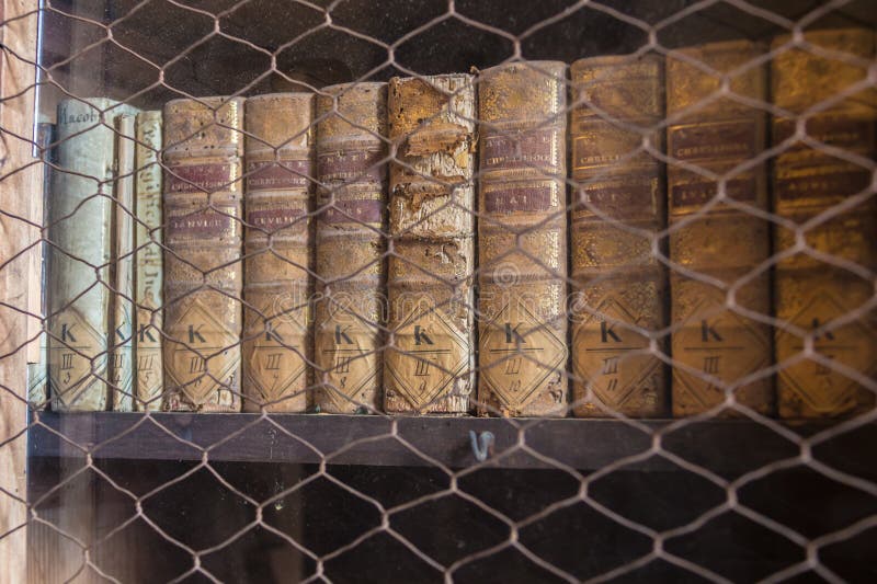 Ancient books on a shelf stock photo. Image of historic - 77763244