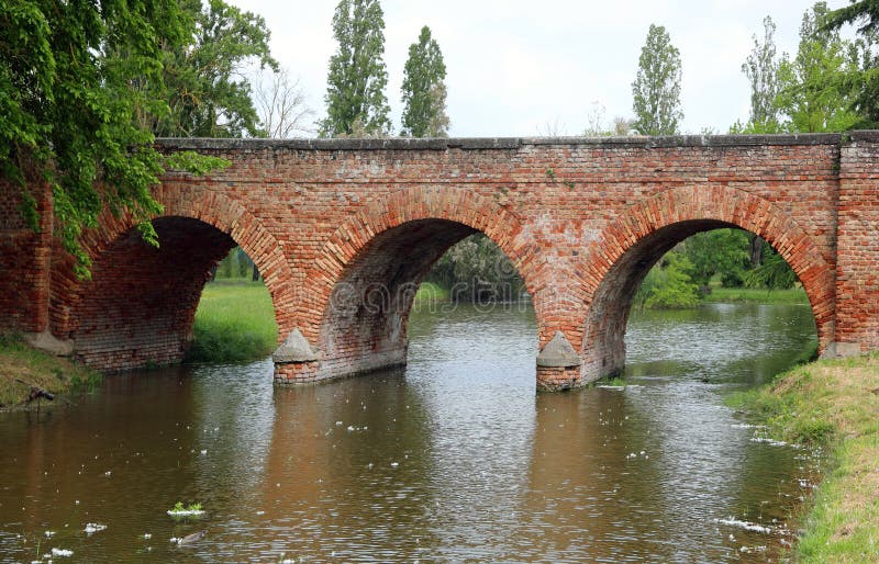 Ancient Three-arched Red Brick Bridge with a Flowing River Underneath ...