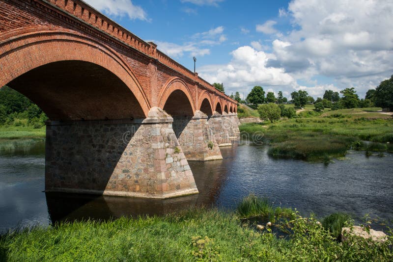 An Ancient Bridge Over the River is Built of Red Bricks Stock Image ...