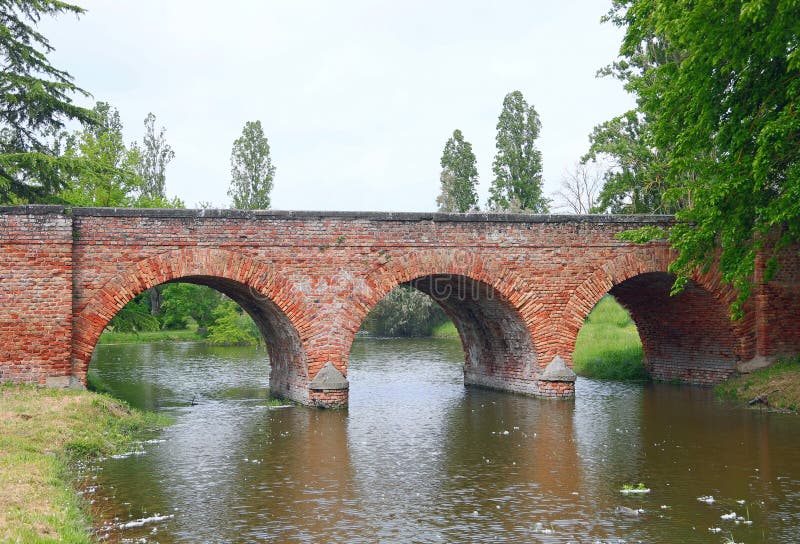 Ancient Bridge with Three Arches Over the Small River Made with Bricks ...