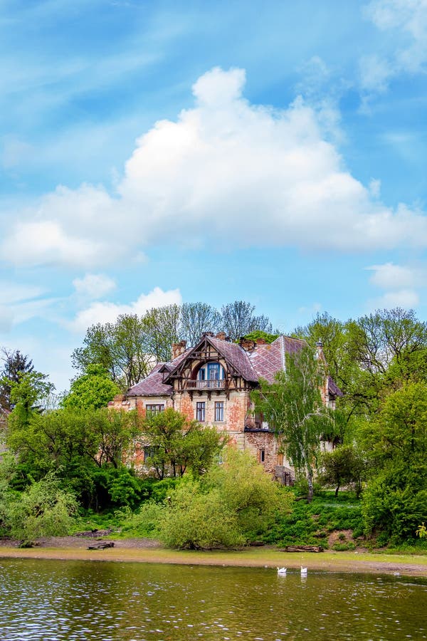 Ancient Building in the Gothic Style on the River Bank Under a Blue Sky ...