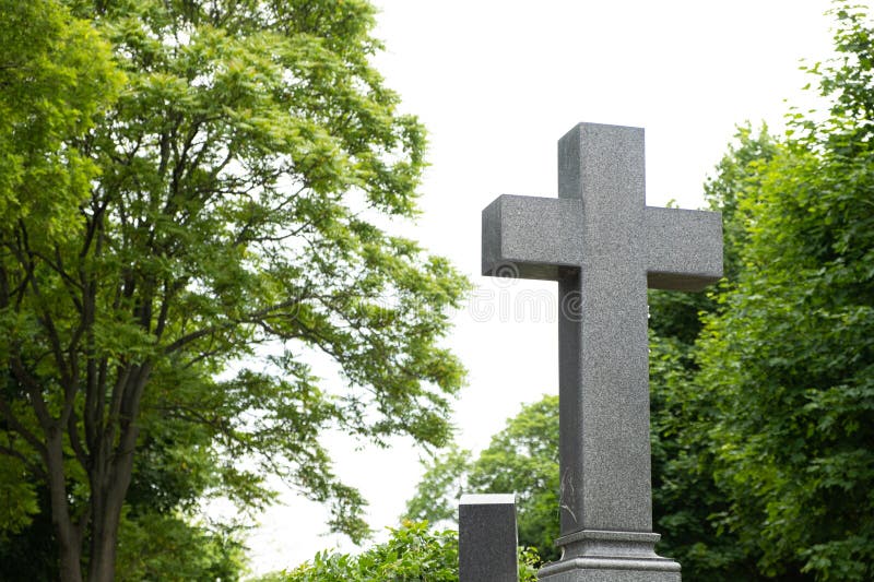 An Ancient Cross in the Cemetery Against the Background of Trees and ...