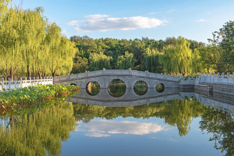 Five Hole Bridge Building with Reflection on Lake Stock Image - Image ...