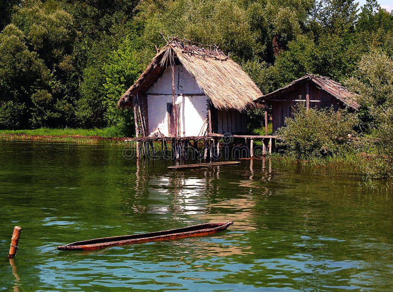 Ancient Hut on Piles at a Green Lake Stock Photo - Image of prehistoric ...