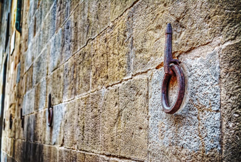 Ancient Iron Hoop Hanging on Stone Wall Stock Image - Image of insured ...