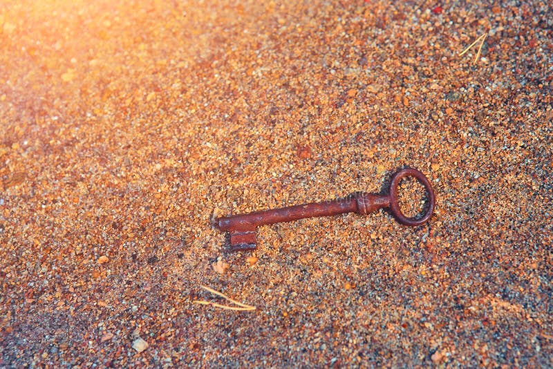An Ancient Key Lies in the Water on the Yellow Sand of the Beach Stock ...