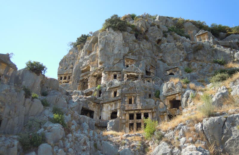 Ancient rocks with caves stock image. Image of rock - 243446363