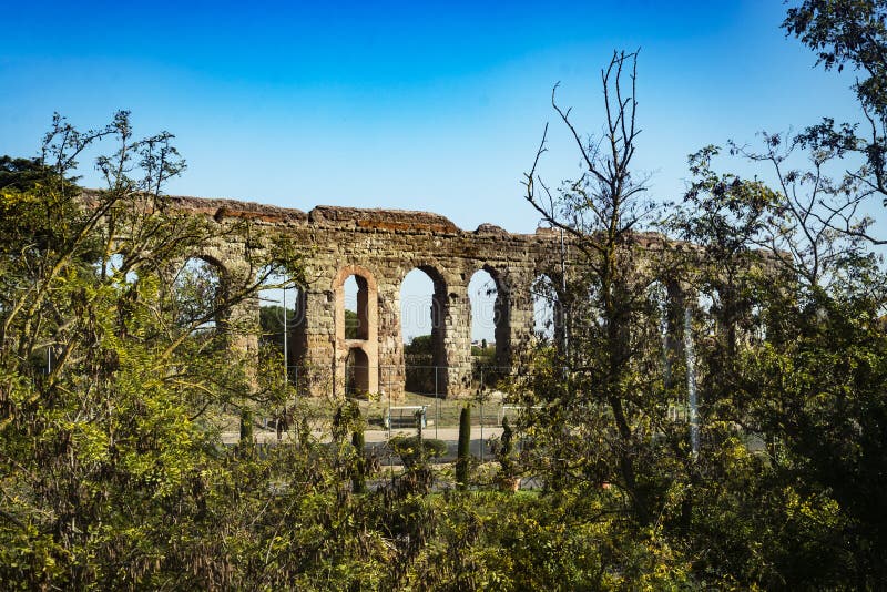Ancient Roman Aqueduct Ouside Rome, Surrounded by Trees Stock Image ...