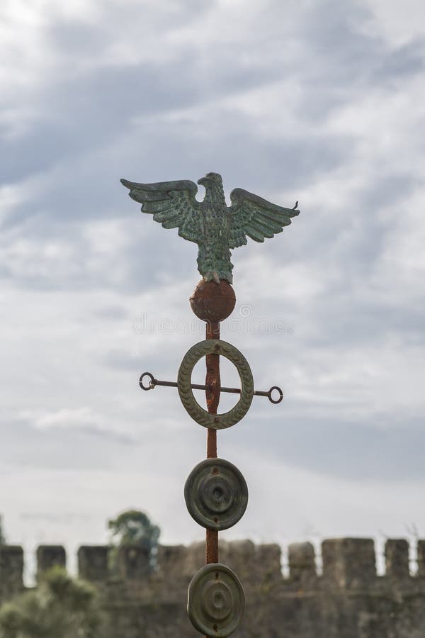 An Ancient Roman Eagle, Covered with Rust and Patina, Against a Cloudy ...