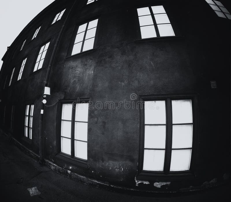 Ancient Run Down Building with Lit Windows in Black and White Stock ...