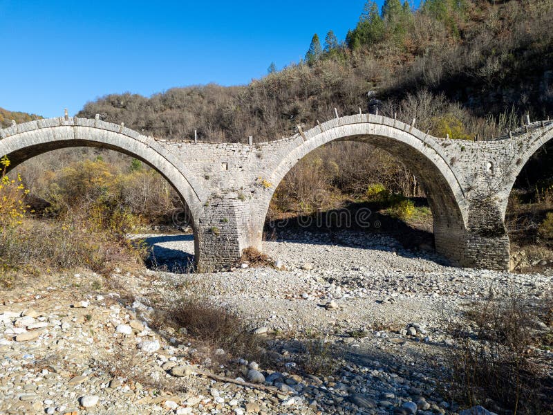 Ancient Stone Bridge Arches Gracefully Over a Rocky Riverbed, a ...
