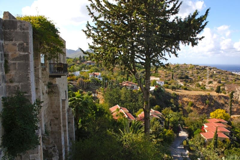 Ancient Stone Building with Lush Greenery and Distant Hills in the ...